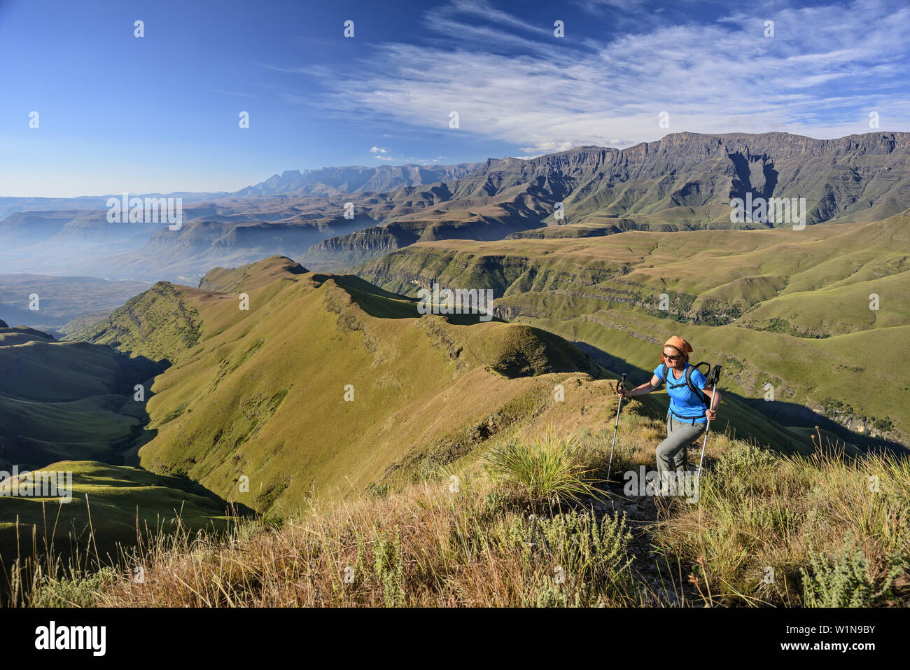 Woman hiking with Cathkin Peak, Champagne Castle, Windsor Castle and ...