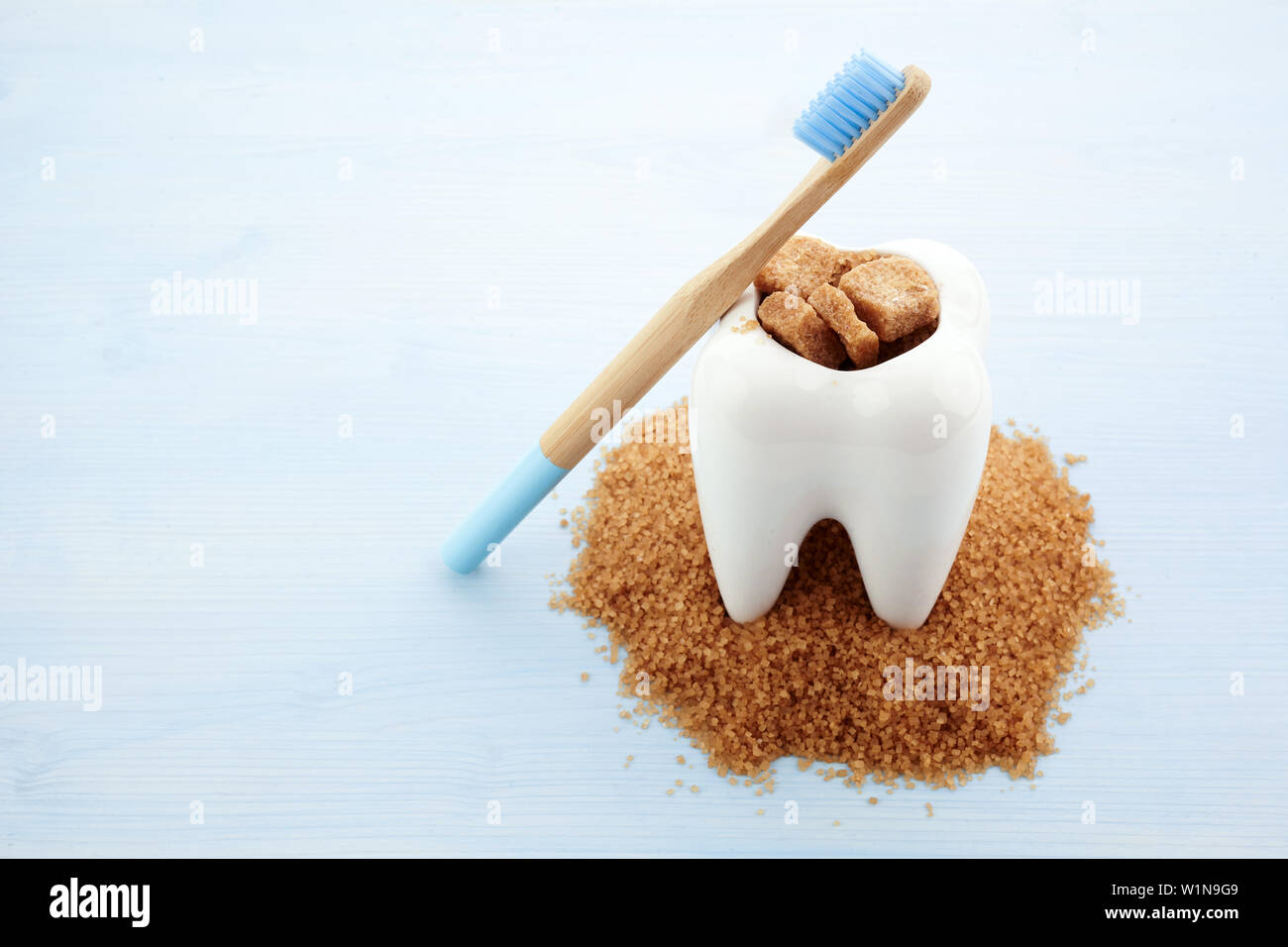 Ceramic tooth in big pile of sugar. Caries and sugar concept. Dental ...