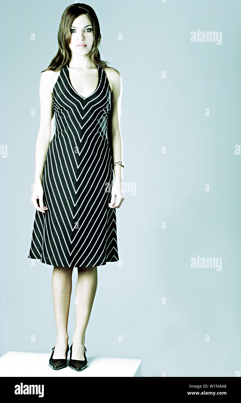 Standing woman, people serious Stock Photo - Alamy