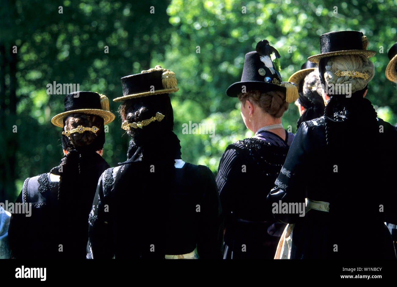 group of women in dirndl dresses from the backside with traditional ...