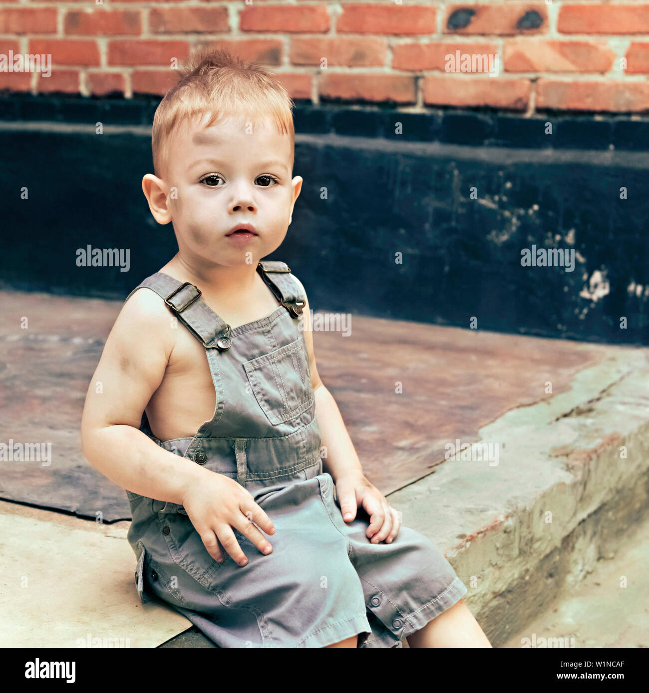 little boy little boy sitting on the steps Stock Photo - Alamy