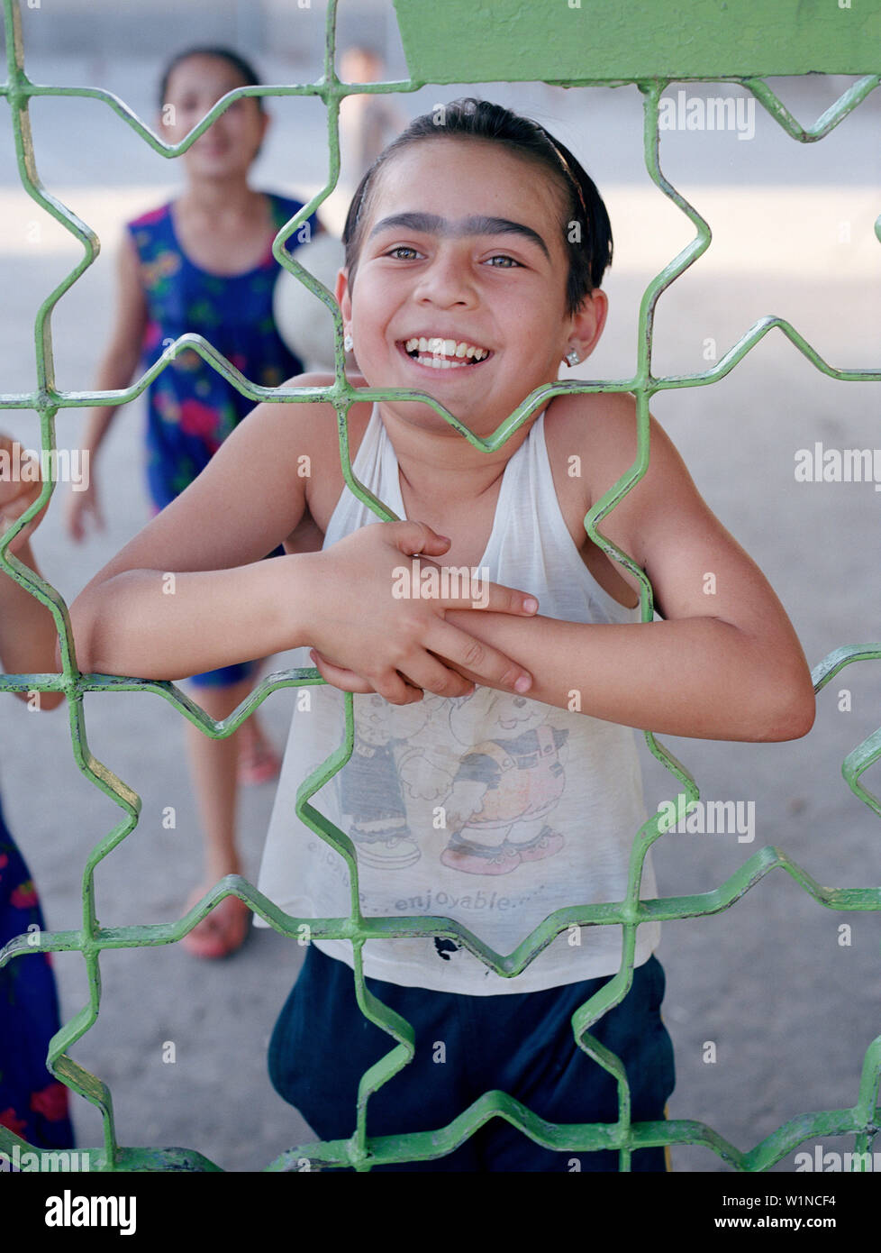 Children behind fence, Silk Road Uzbekistan Stock Photo - Alamy
