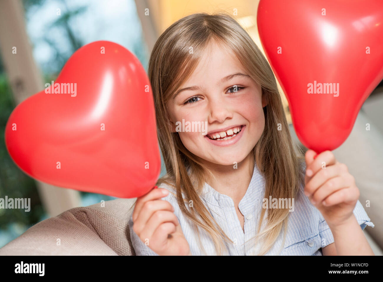 Girl heart shaped balloons' hi-res stock photography and images - Alamy