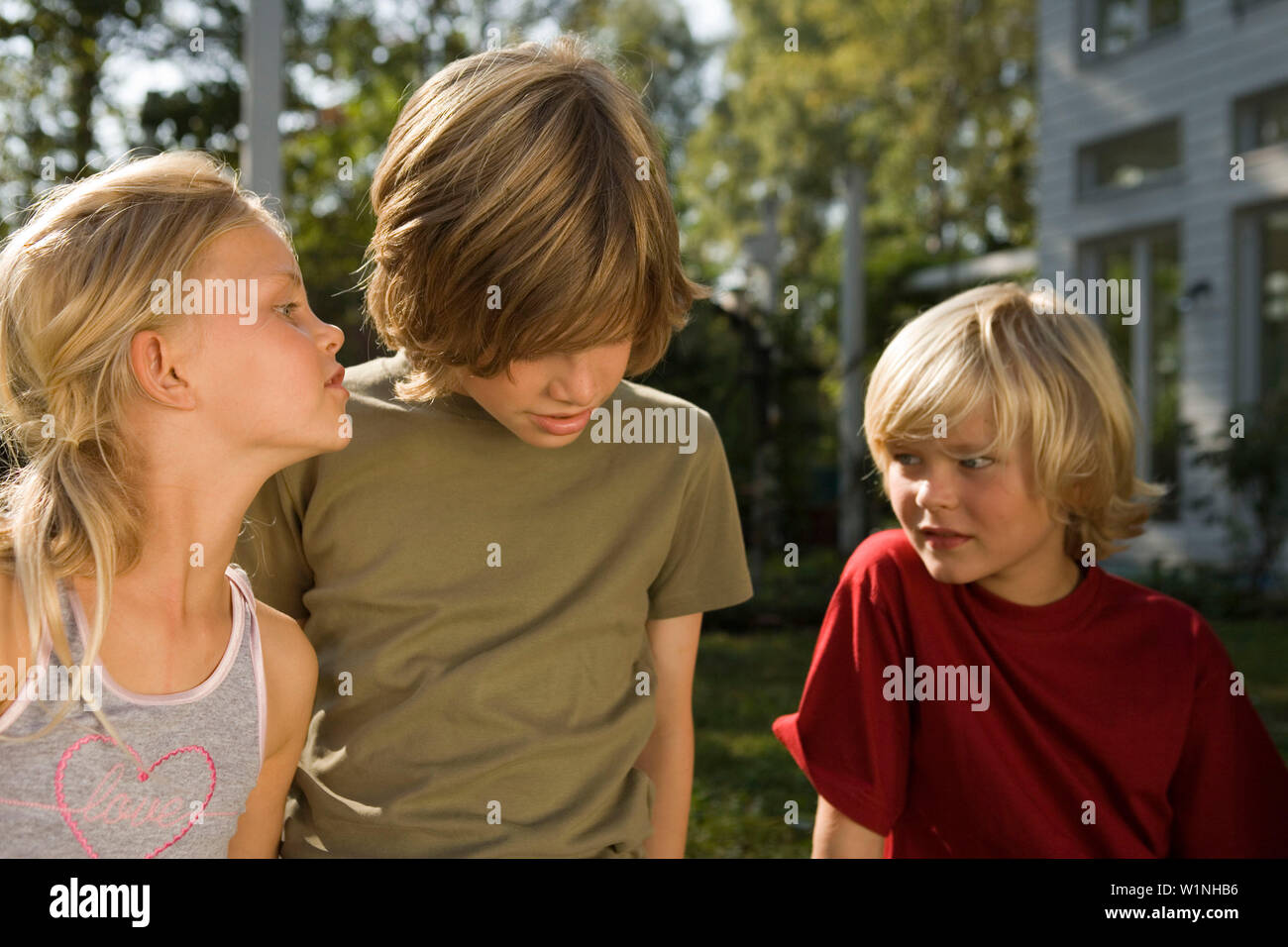 Children playing Chinese whisper, children's birthday party Stock Photo ...