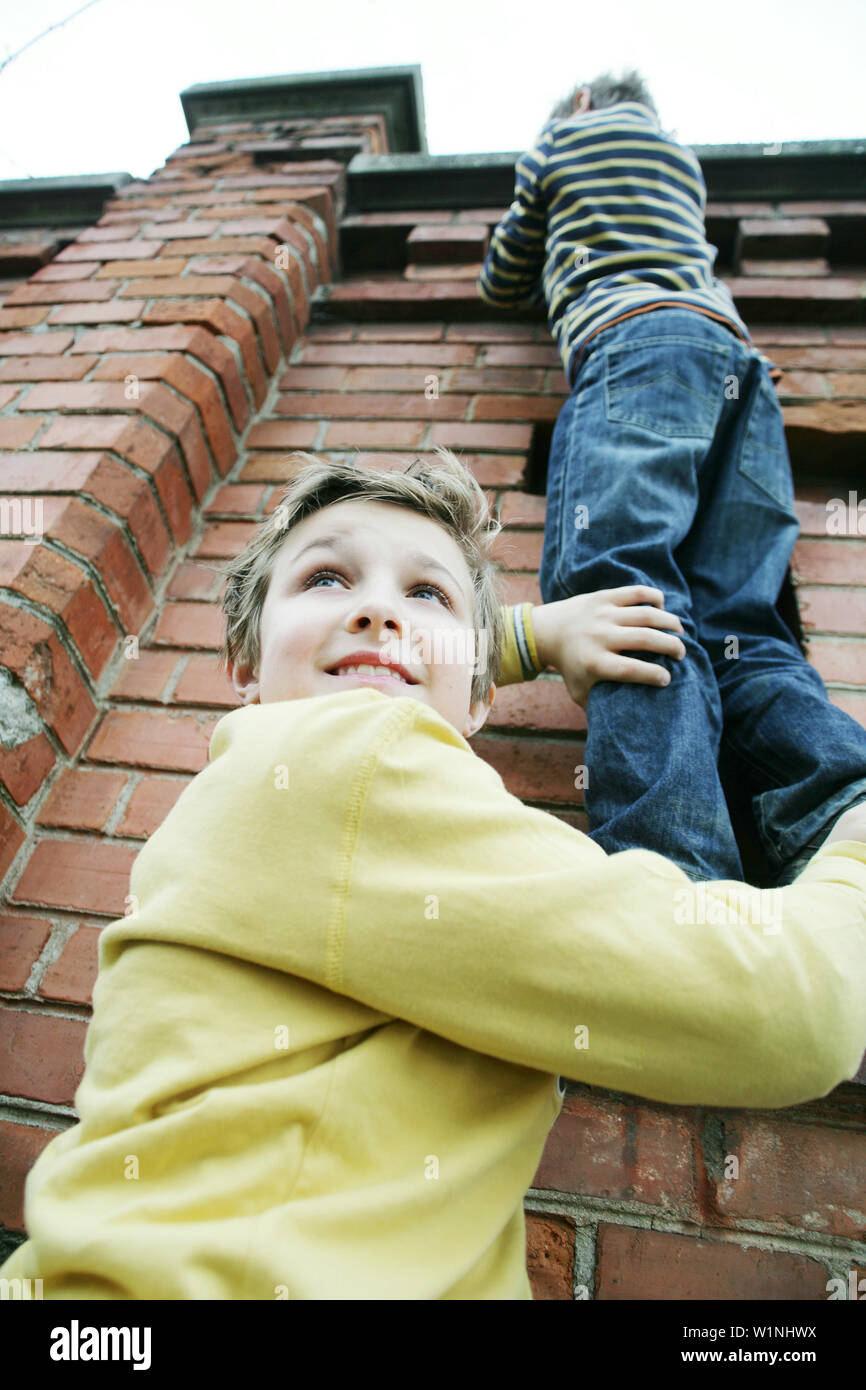 Helping over wall hi-res stock photography and images - Alamy