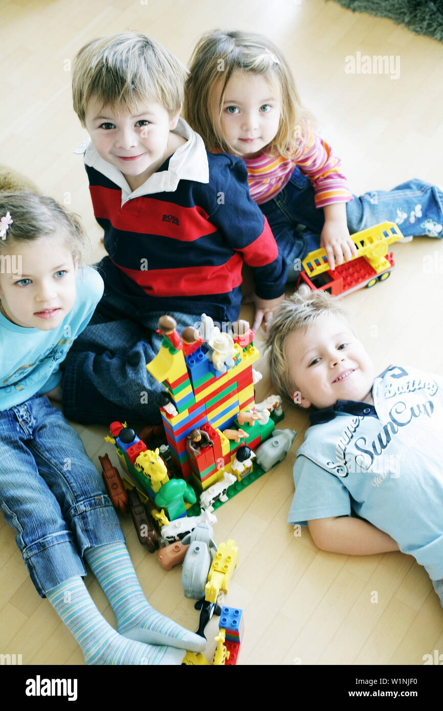 Children playing with plastic bricks Stock Photo - Alamy