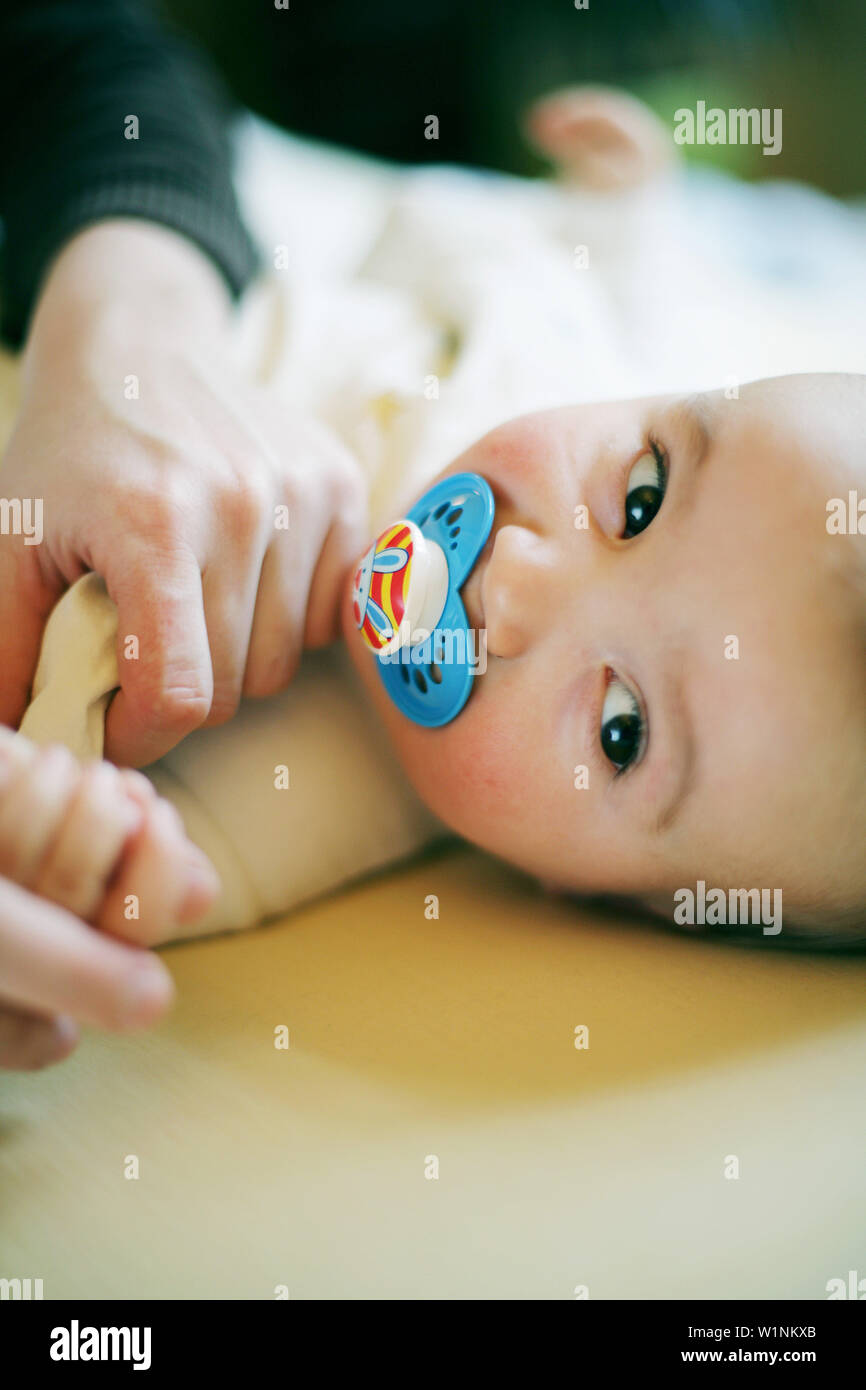 Baby being wrapped in a blanket Stock Photo - Alamy