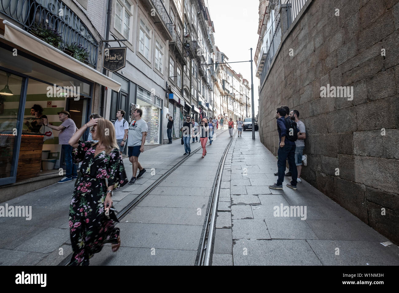 People walking in the beautiful and typical streets of Porto on a ...