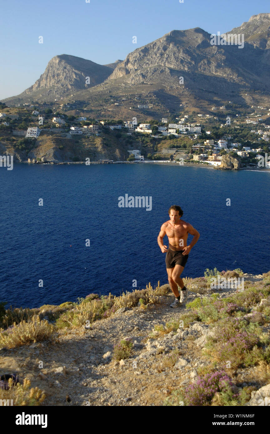 Jogging on cliff line of Kalymnos, Kalymnos, Greece Stock Photo - Alamy