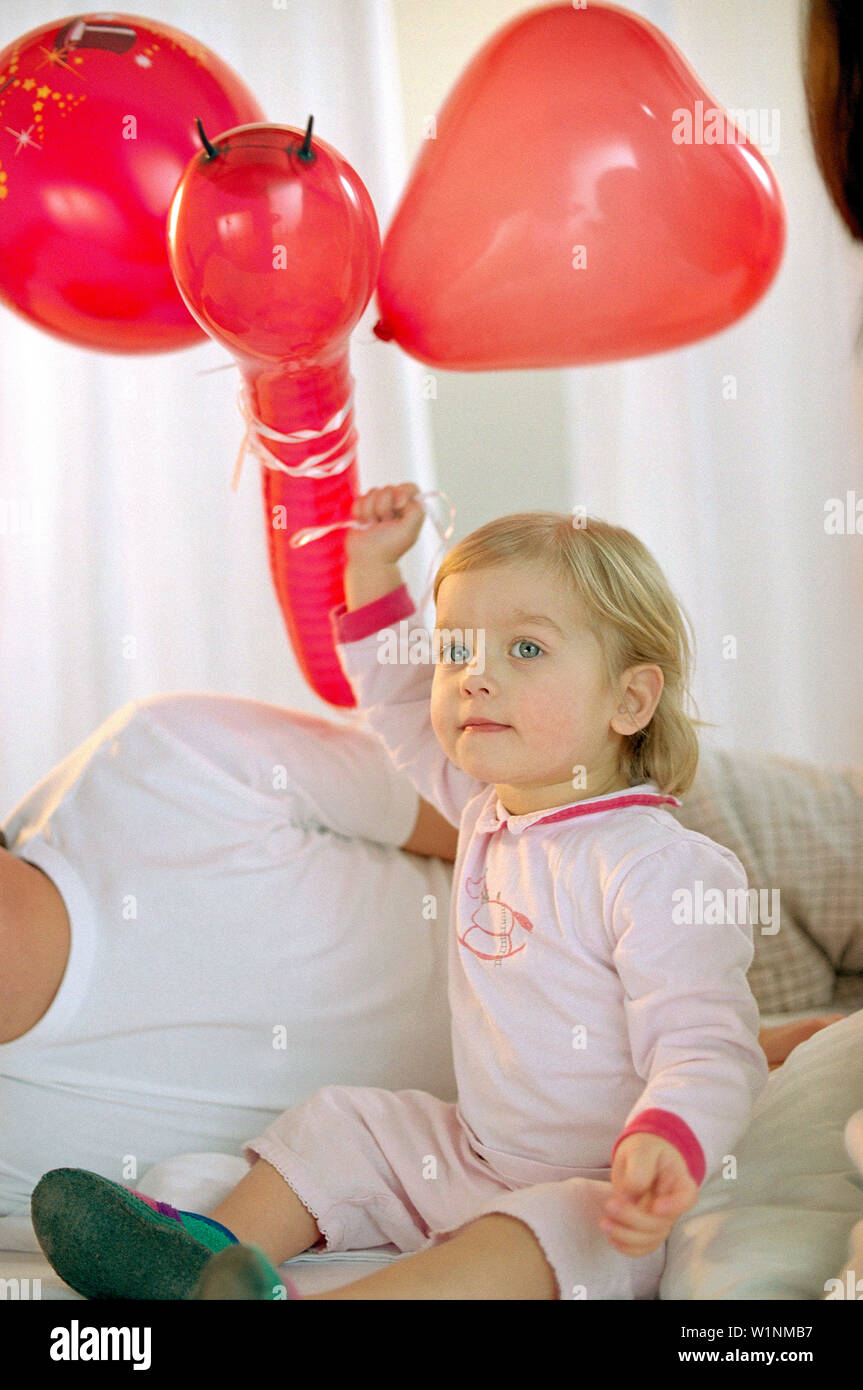 Little girl with red balloons Stock Photo - Alamy