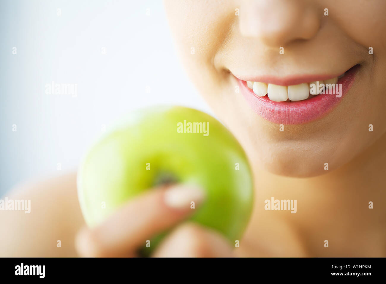 Woman Eating Apple. Beautiful Girl With White Teeth Biting Apple. High ...