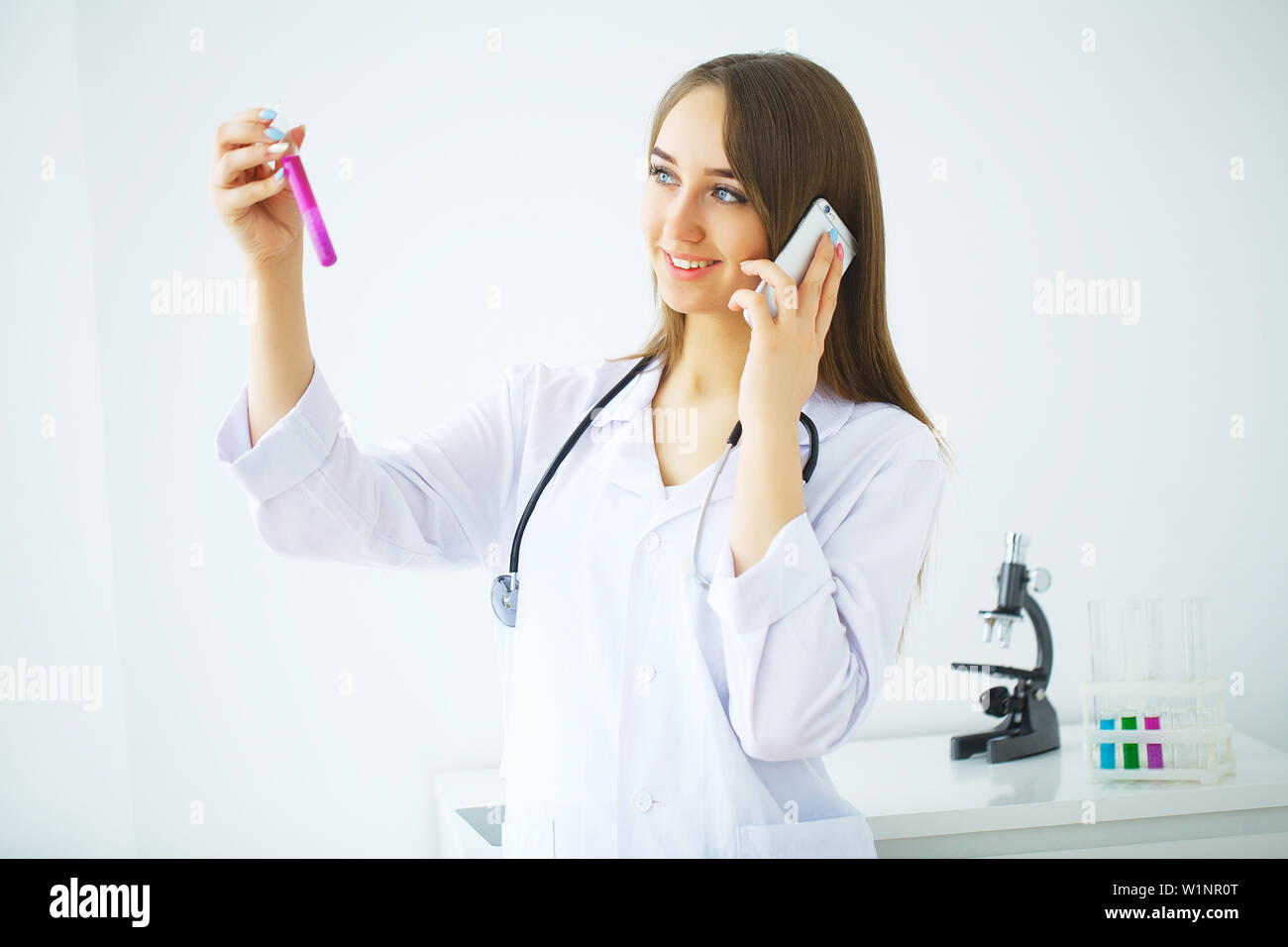 Female Scientific Research Team With Clear Solution In Laborator Stock ...