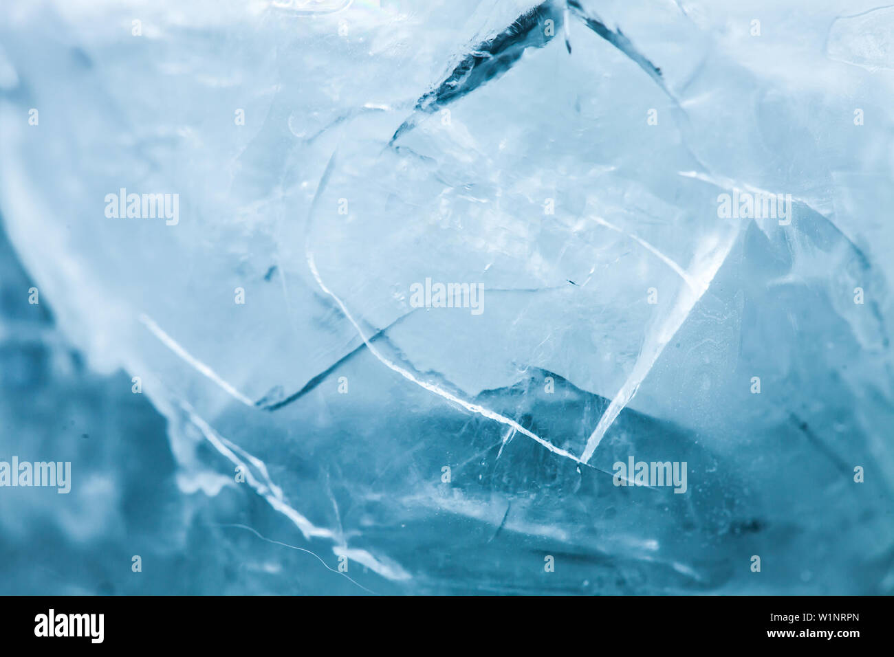 blue cracked ice. texture of frozen water Stock Photo - Alamy