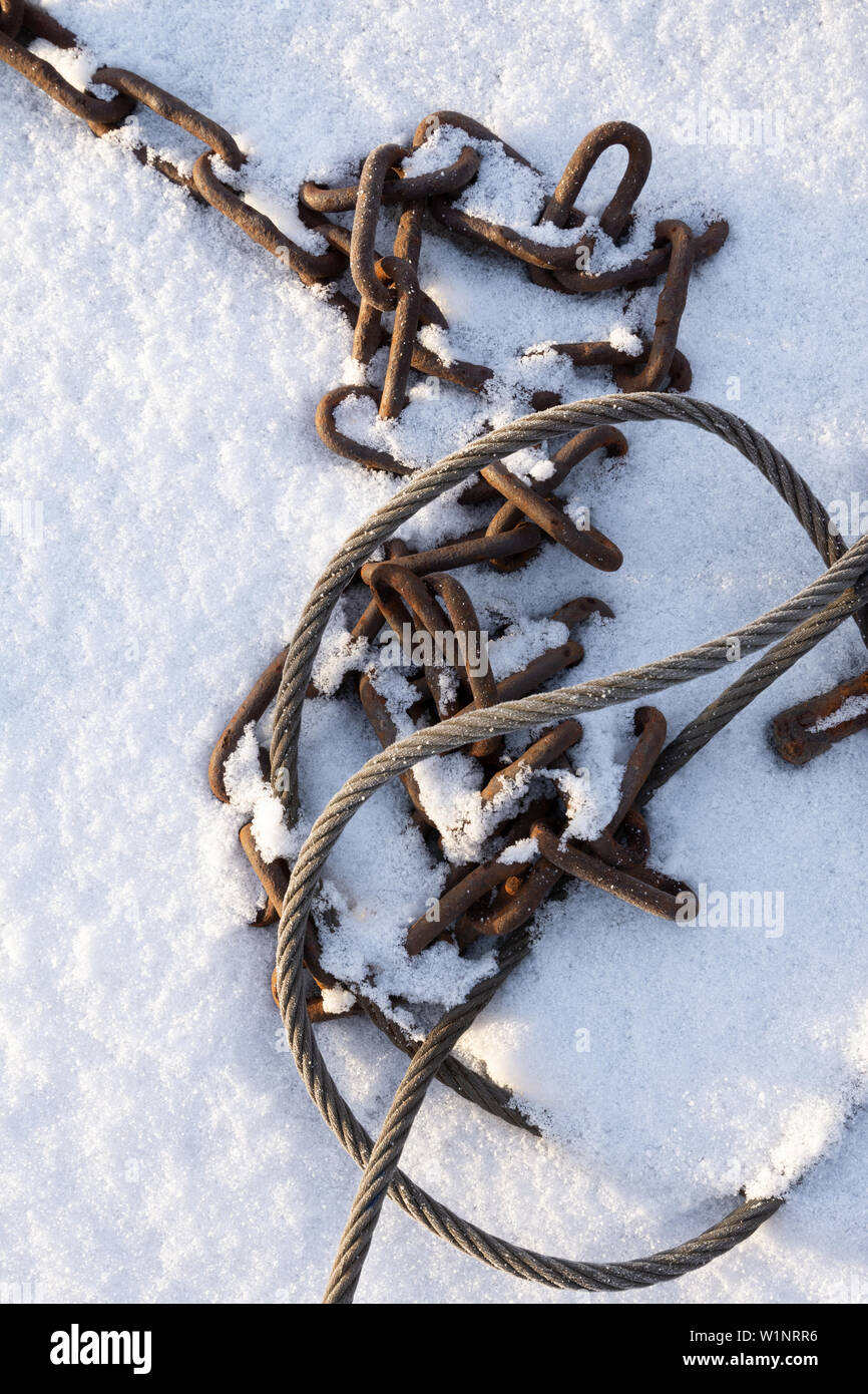 Steel wire rope cable and rusty chain in snow Stock Photo - Alamy