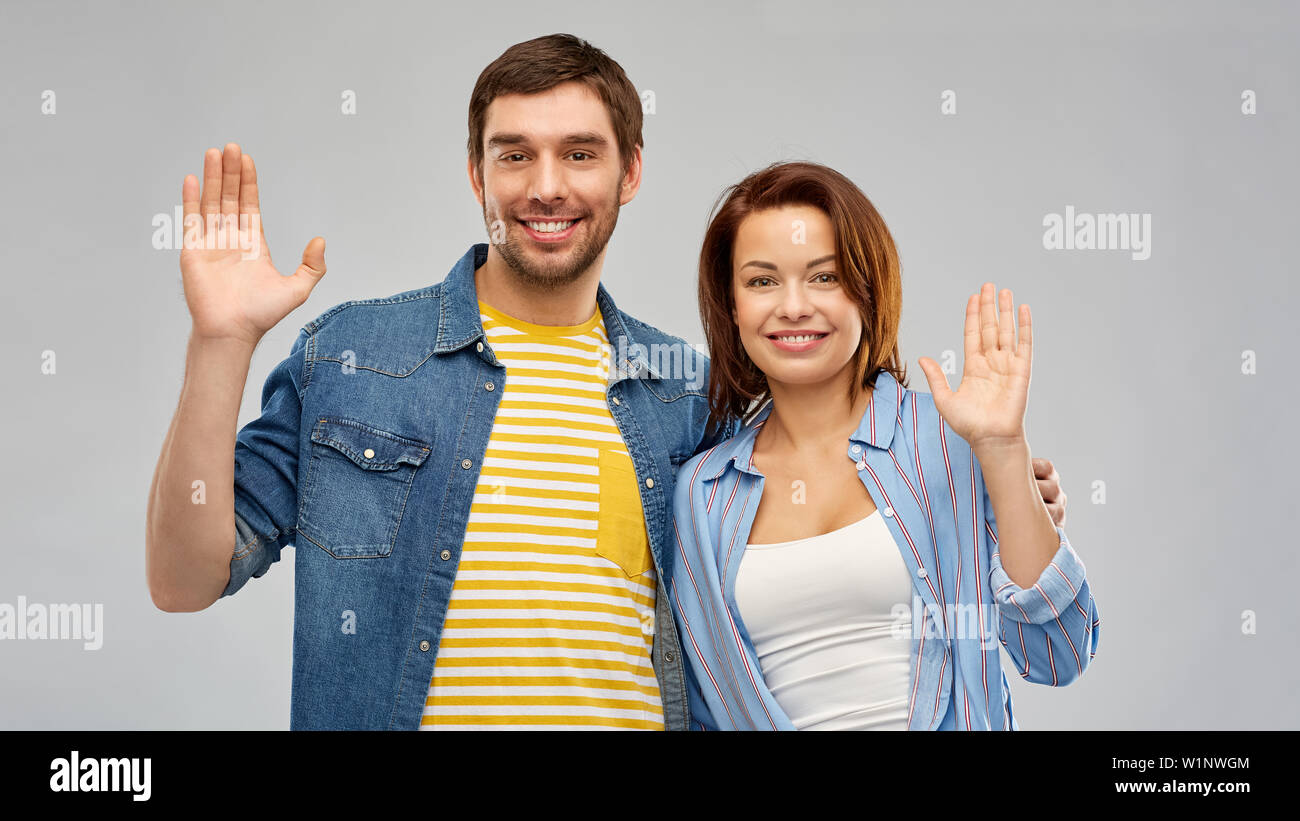 happy couple waving hands Stock Photo - Alamy