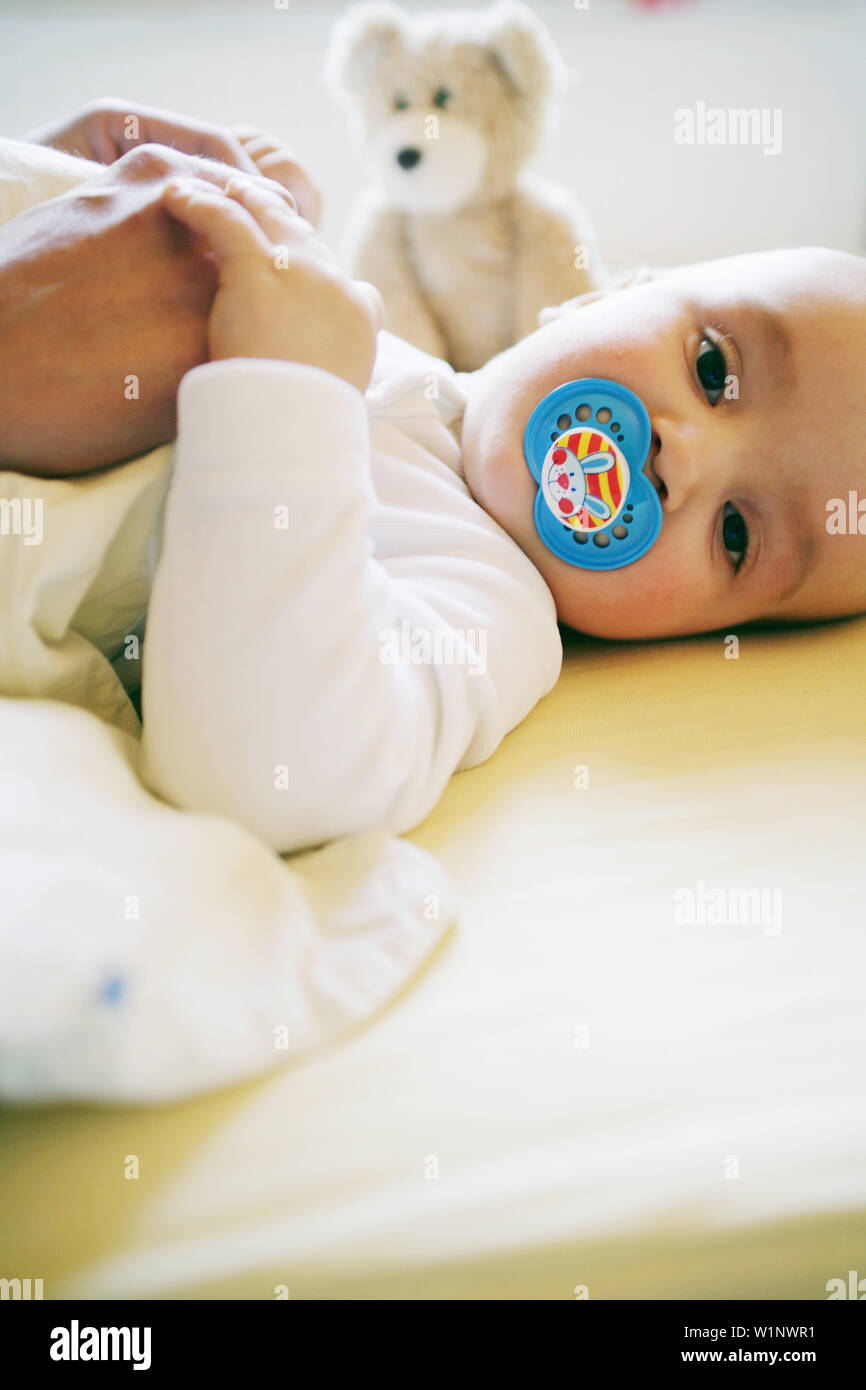Baby is being covered Stock Photo - Alamy