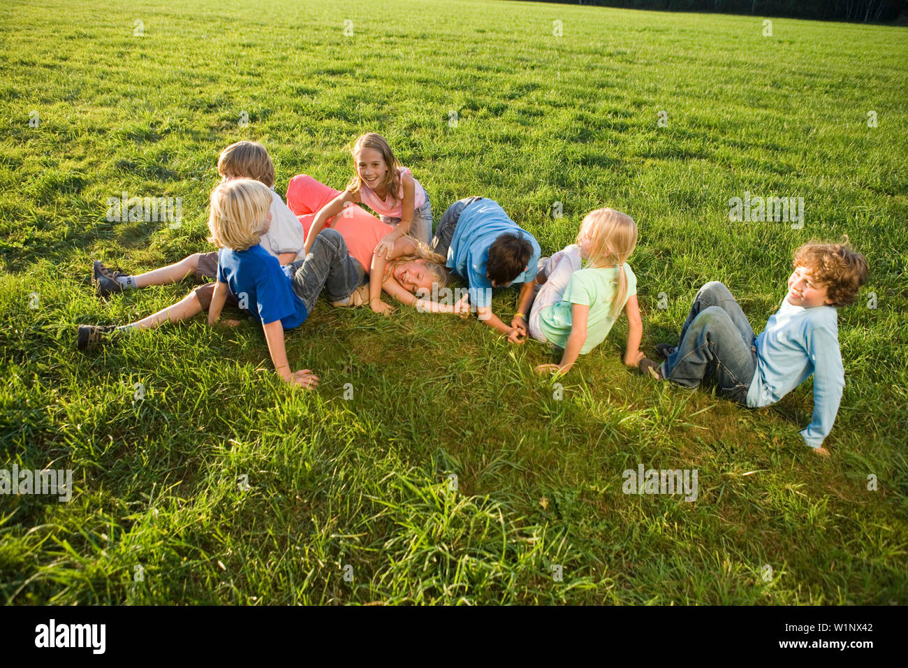 Children playing on grass, children's birthday party Stock Photo - Alamy