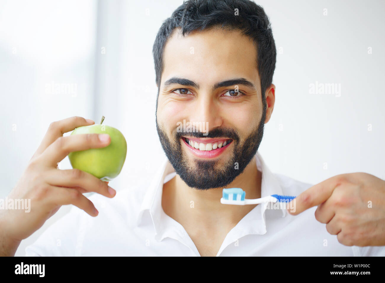 Man Eating Apple. Beautiful Girl With White Teeth Biting Apple. High ...