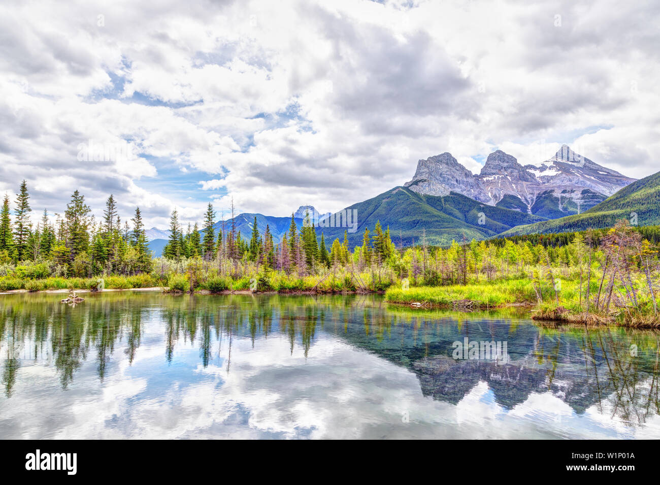 Canmore's famous Three Sisters mountain peaks and their reflections on ...