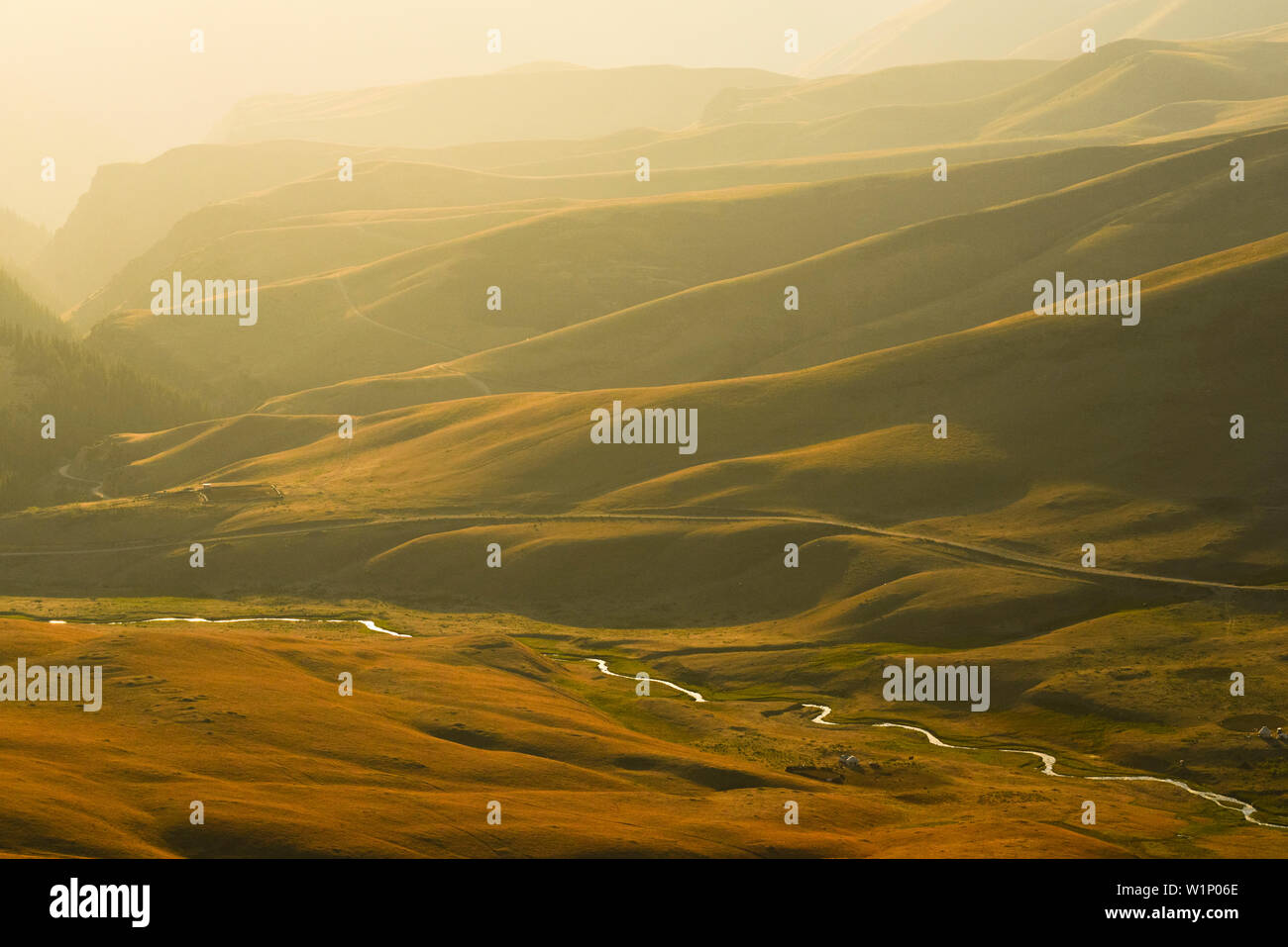 Steppe landscape with mountain ranges, river and jurts at Assy Plateau ...