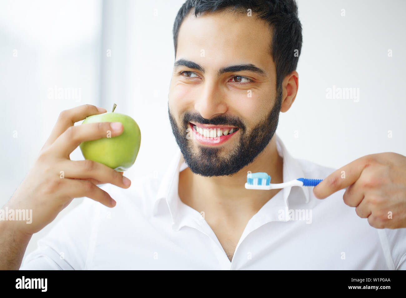 Man Eating Apple. Beautiful Girl With White Teeth Biting Apple. High ...