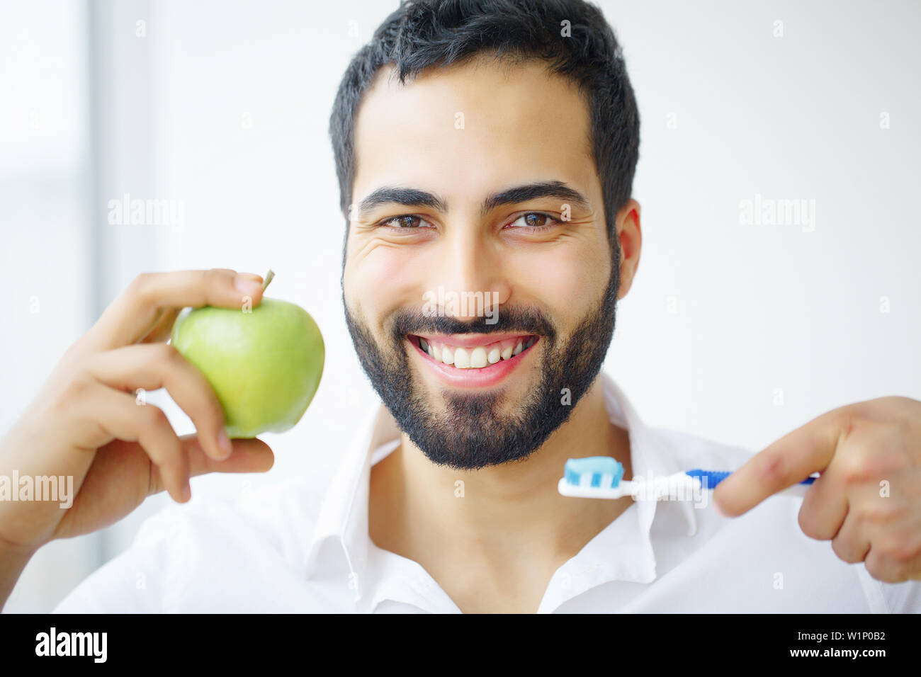 Man Eating Apple. Beautiful Girl With White Teeth Biting Apple. High ...