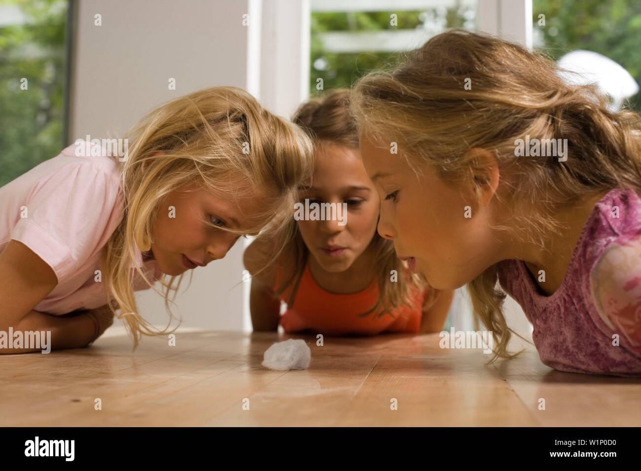 Three girls playing Blowing Cotton Wool, children's birthday party ...