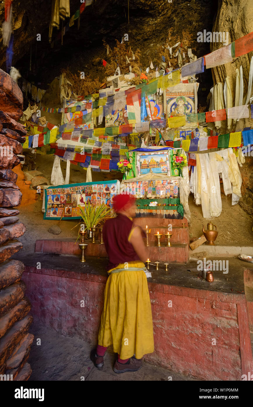 Monch at the altar of the Ranchung Cave, Buddhist monastery, cave ...