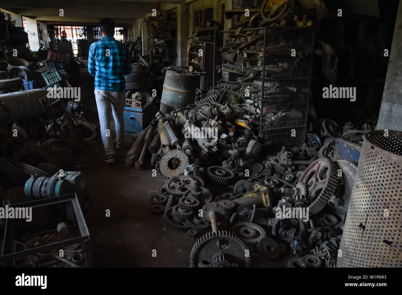 A customer looks for usable material inside a scrap shop in Srinagar ...