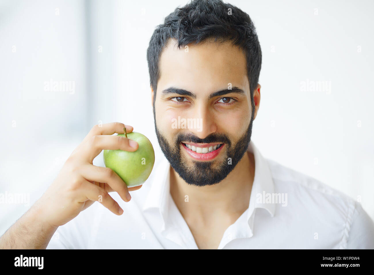 Man Eating Apple. Beautiful Girl With White Teeth Biting Apple. High ...