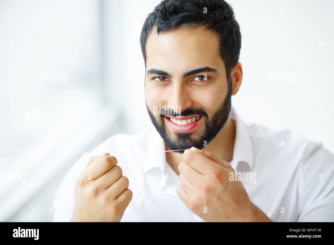 Dental Health. Man With Beautiful Smile Flossing Healthy Teeth. High ...