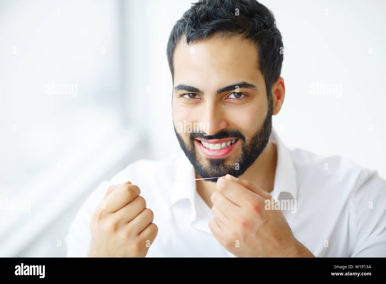 Dental Health. Man With Beautiful Smile Flossing Healthy Teeth. High ...