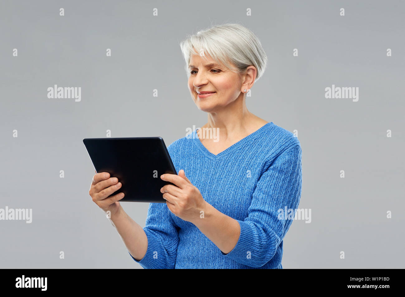 senior woman in glasses using tablet computer Stock Photo - Alamy