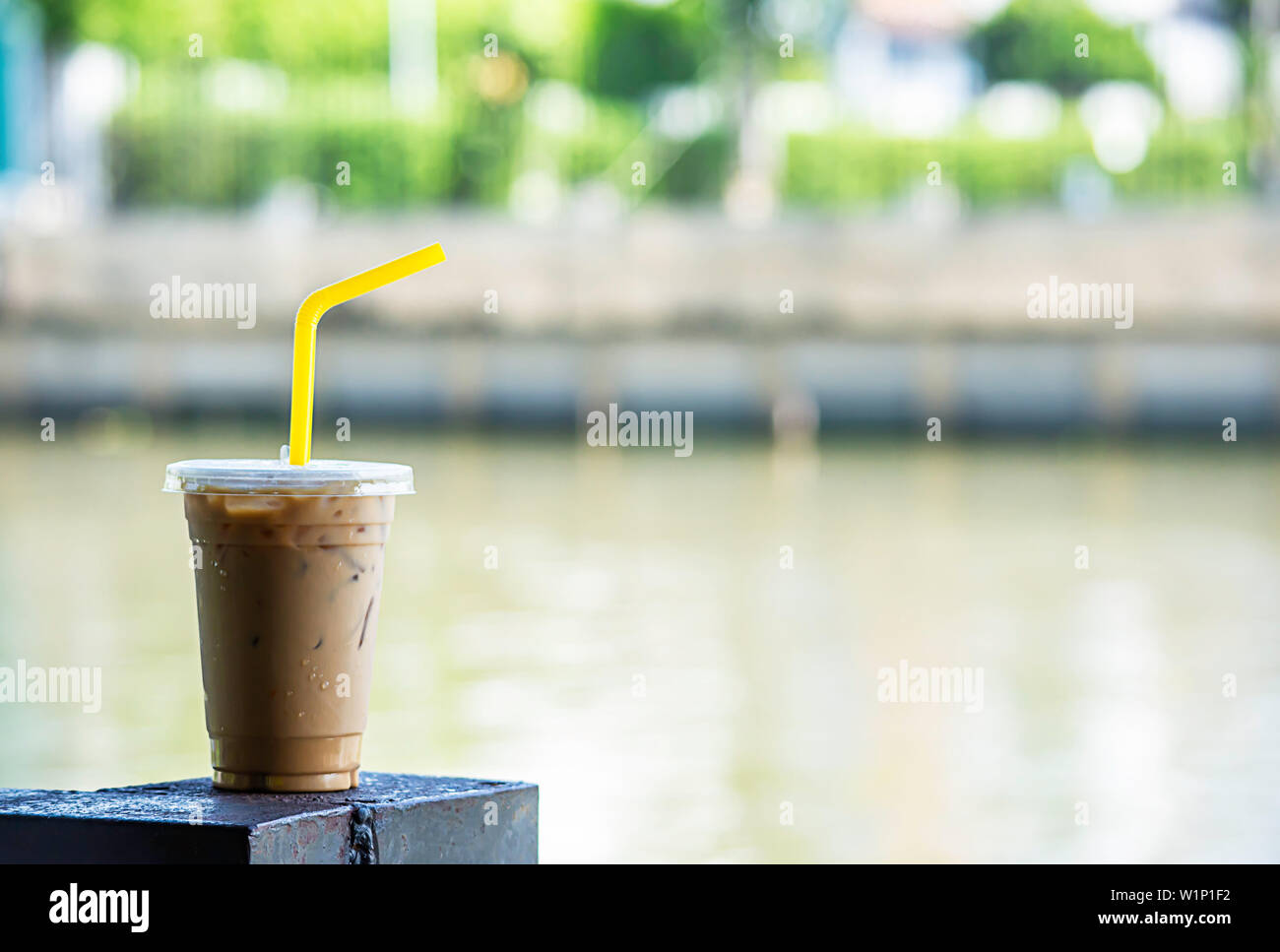 Iced coffee in a glass On the steel rod Blur background river Stock ...
