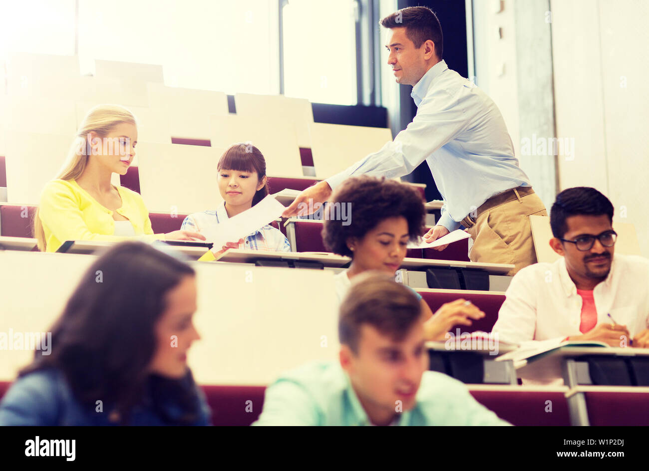 teacher giving test to students on lecture Stock Photo - Alamy