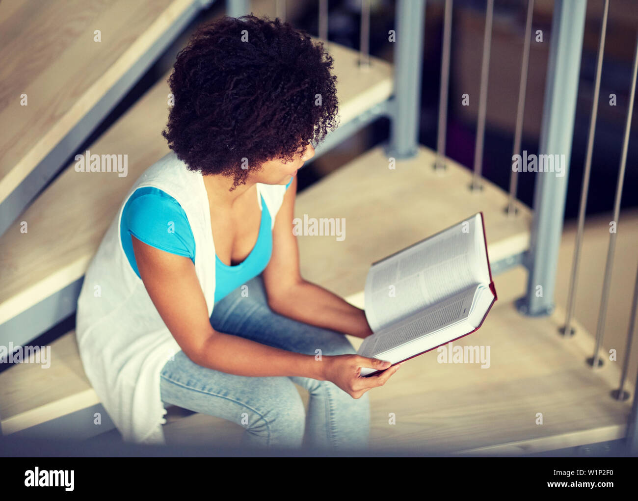 african student girl reading book at library Stock Photo - Alamy