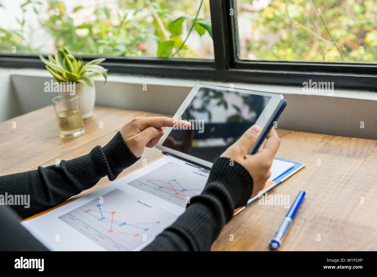 Close up of female hand holding and tapping tablet screen Stock Photo ...