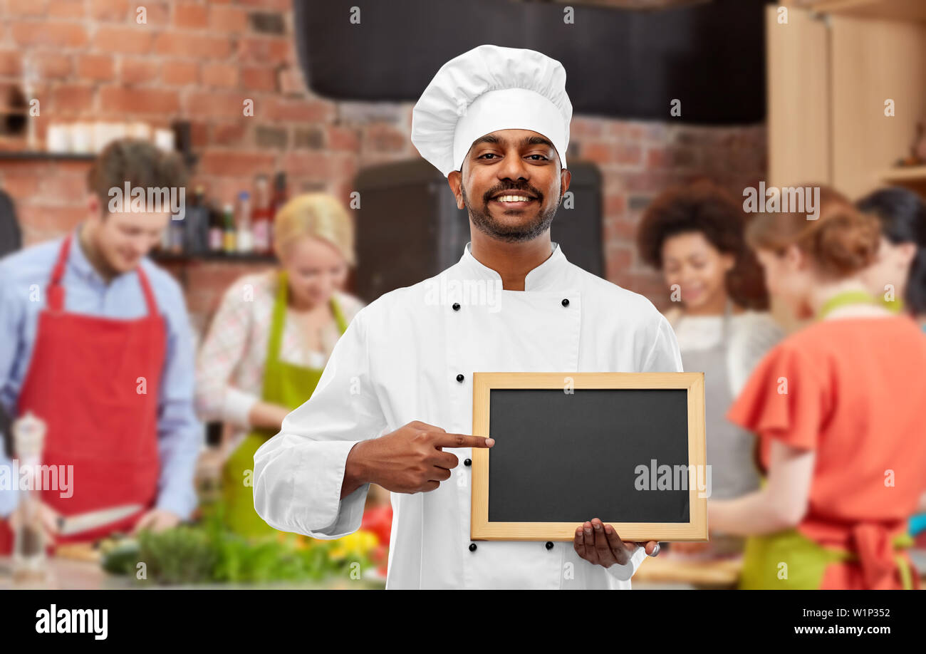 happy indian chef with chalkboard at cooking class Stock Photo - Alamy