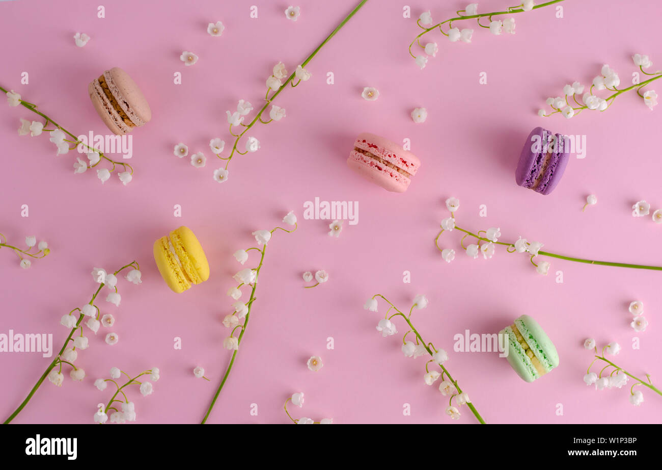 Colorful macarons or macaroons decorated with blooming lily of the ...