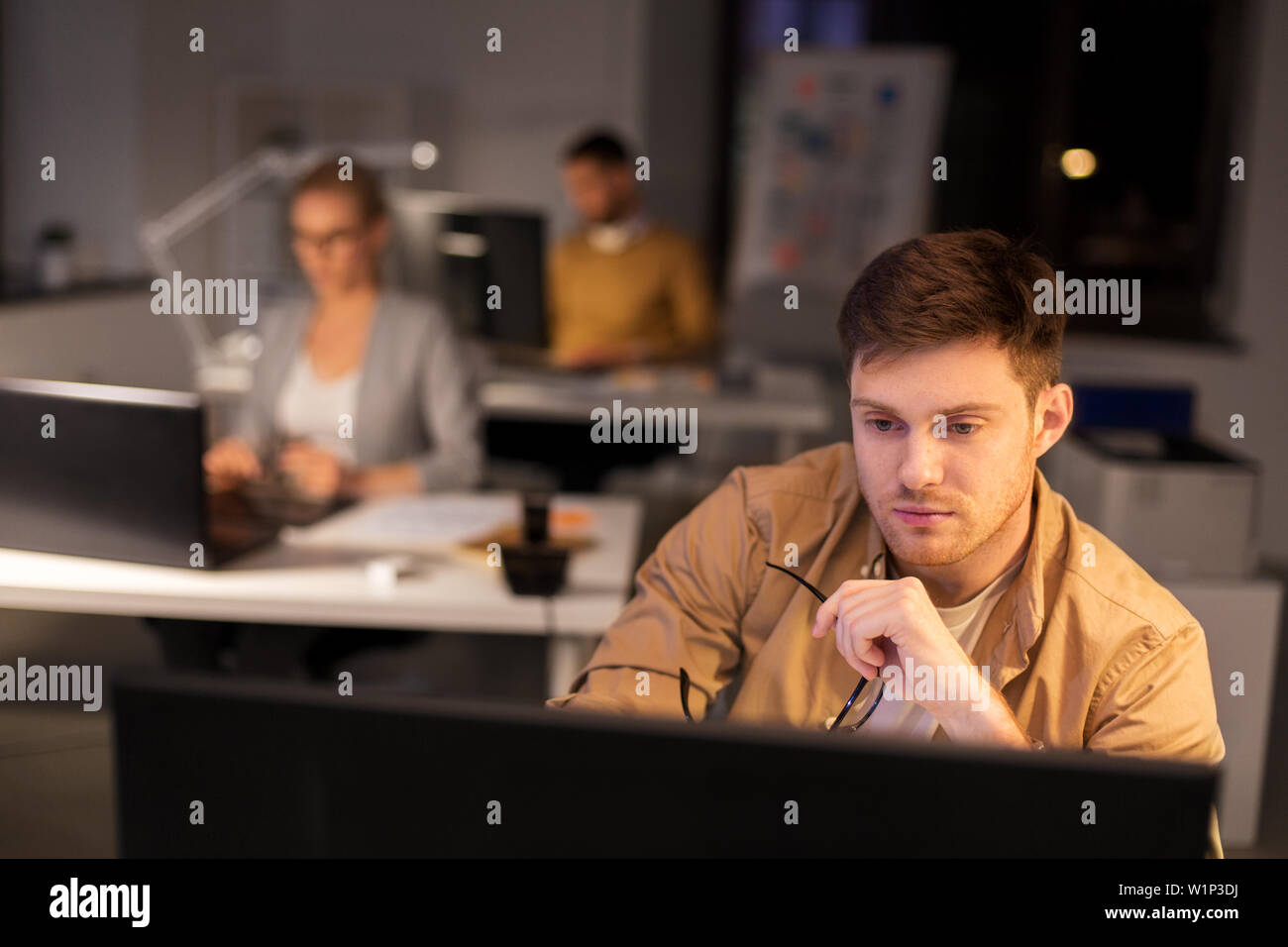 man with computer working late at night office Stock Photo - Alamy