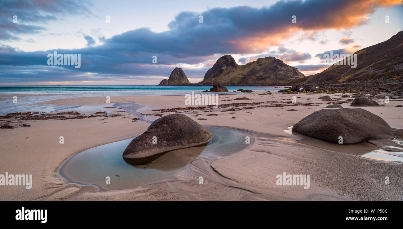 tidal pool in the midnight sun on a sandy beach near the city of Sto ...
