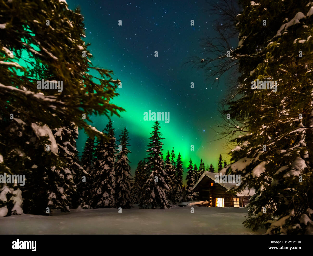 log cabin with northern lights in Luosto, Pyhä-Luosto National park ...