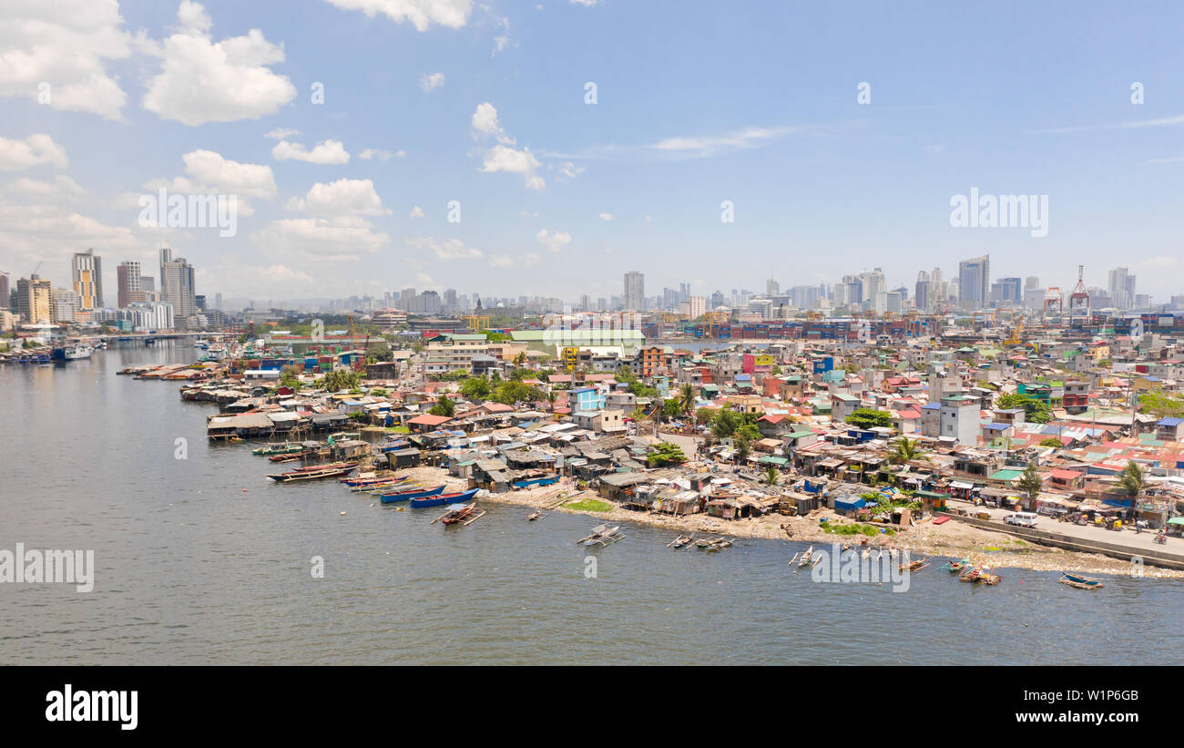 The urban landscape of Manila, with slums and skyscrapers. Sea port and ...
