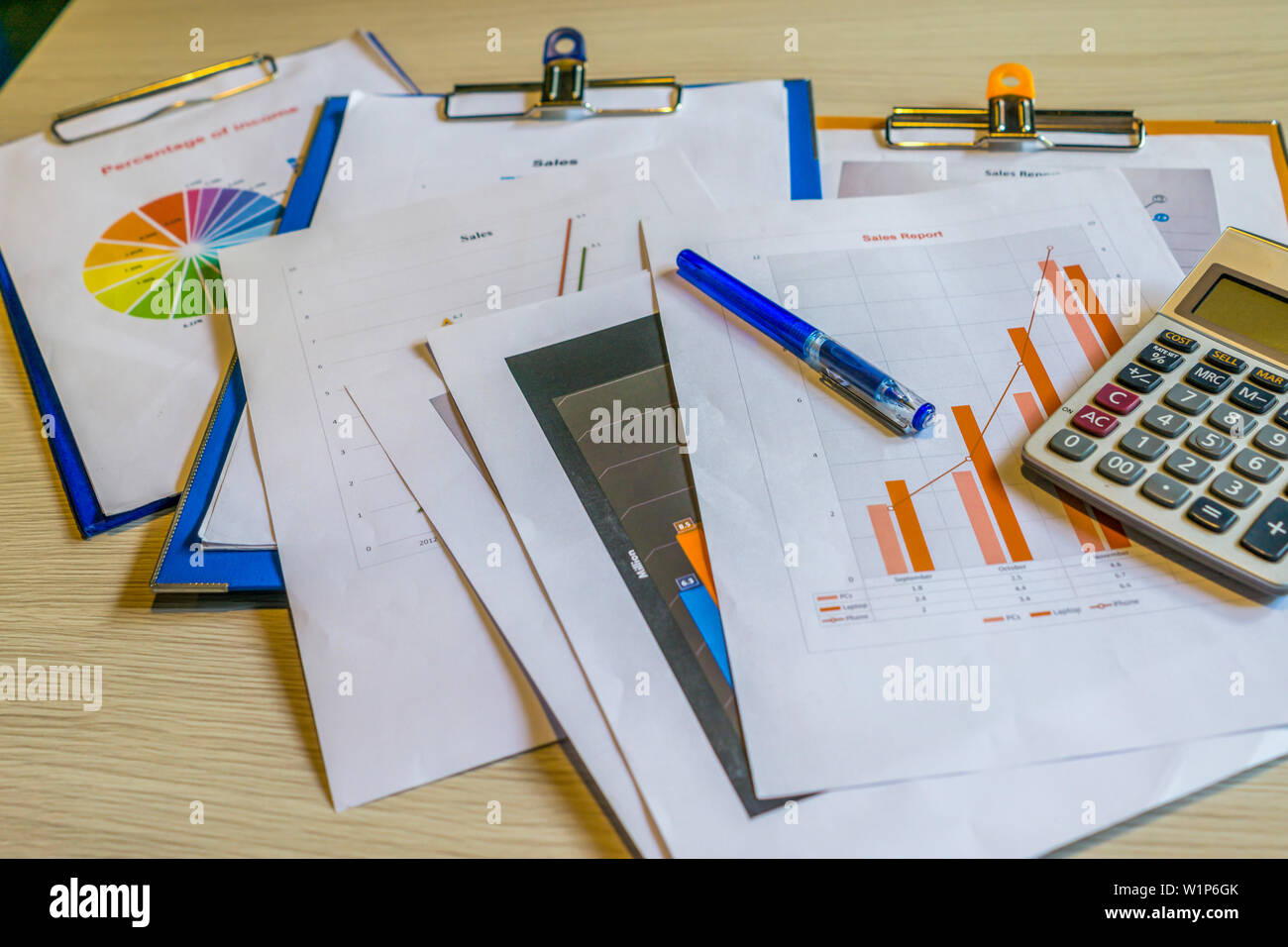 Calculator and pie chart graph documents on table Stock Photo - Alamy