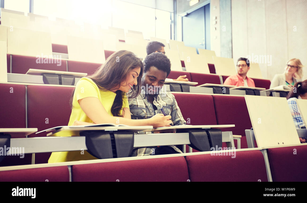 group of students with notebooks at lecture hall Stock Photo - Alamy