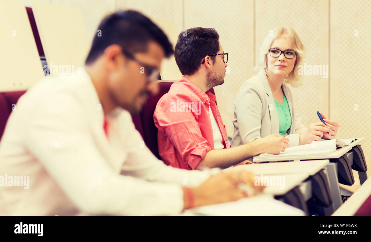 group of students with notebooks in lecture hall Stock Photo - Alamy