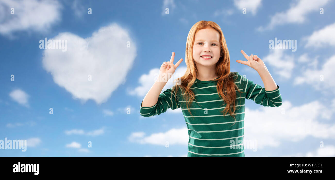 smiling red haired girl showing peace over sky Stock Photo - Alamy
