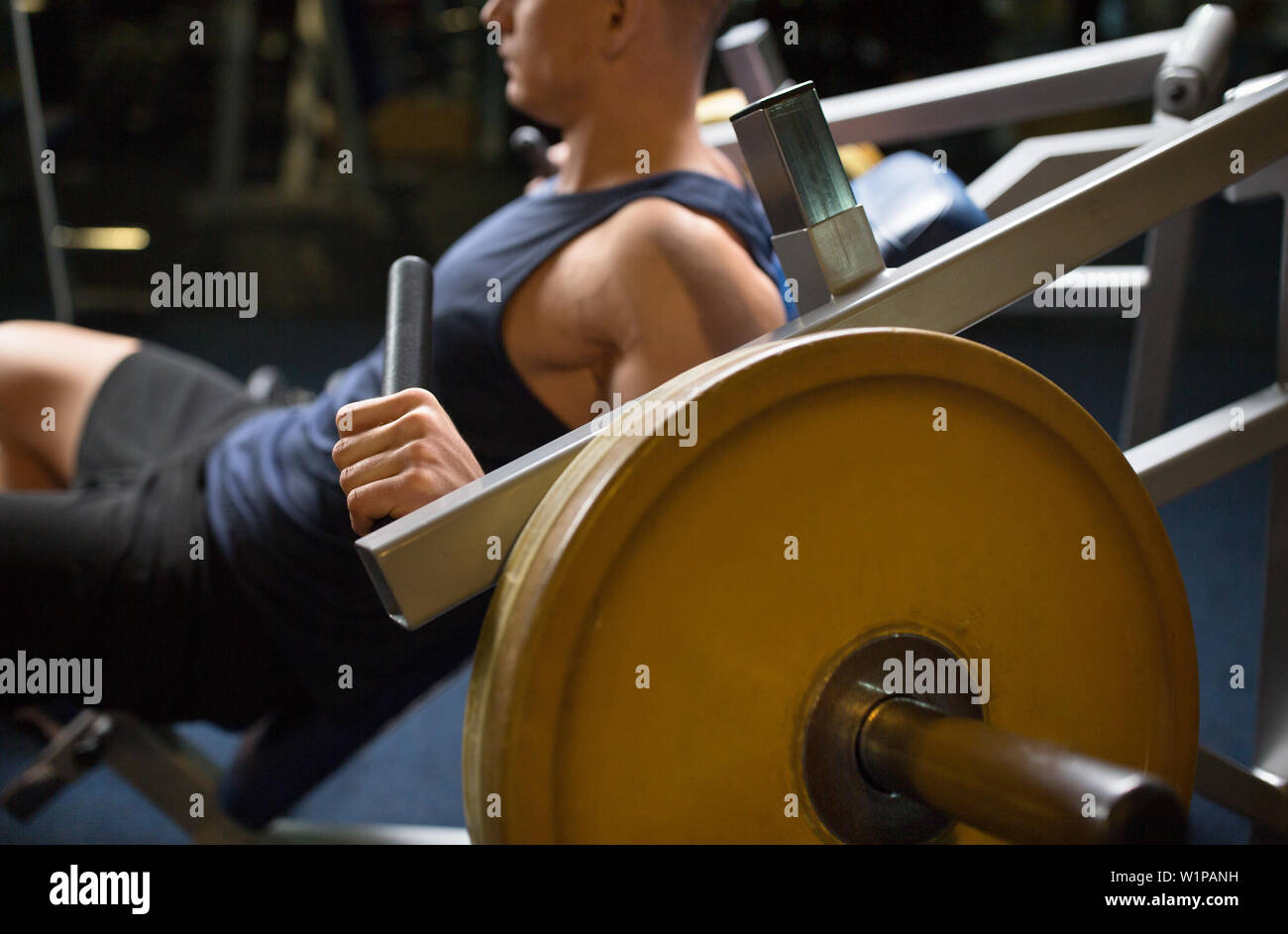 close up of man exercising on gym machine Stock Photo - Alamy