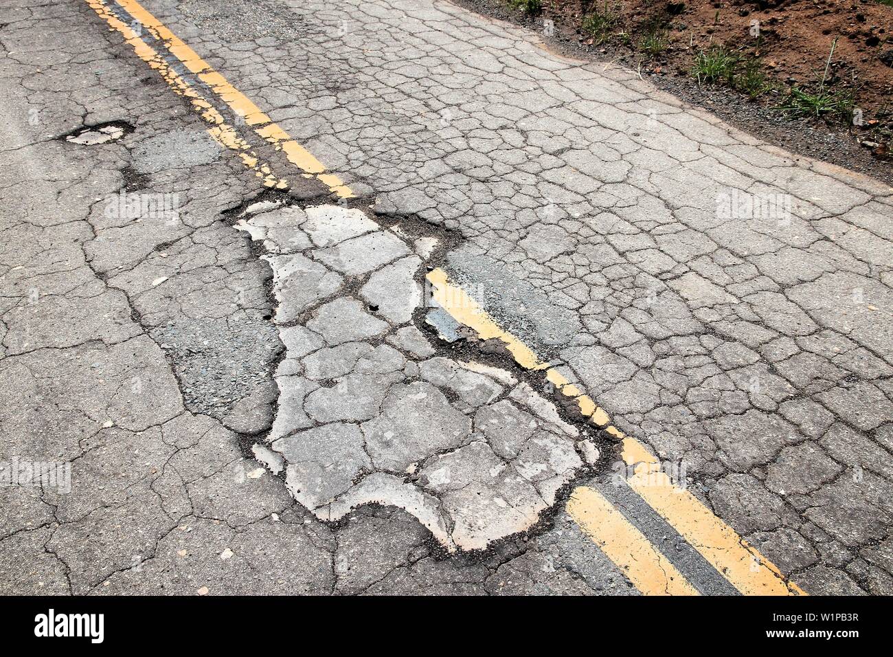 Pothole road - damaged roadway surface in California, USA Stock Photo ...