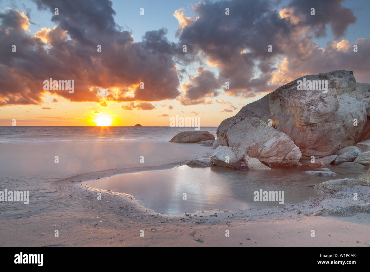 Sunrise over the sea, rocks on the beach of Pinarellu, East Corsica ...